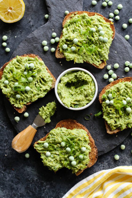 Lemon-y Smashed Pea Toasts by Flora & Vino with herbs and garnishes