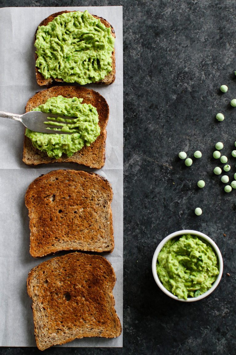 Lemon-y Smashed Pea Toasts by Flora & Vino with herbs and garnishes