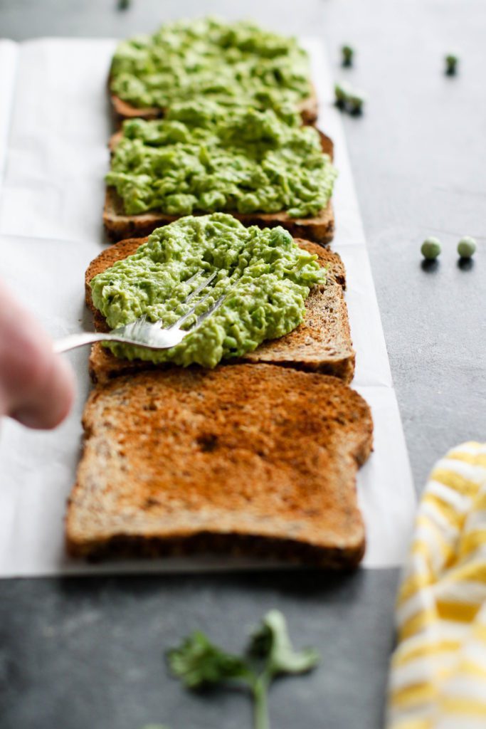 Lemon-y Smashed Pea Toasts by Flora & Vino with herbs and garnishes